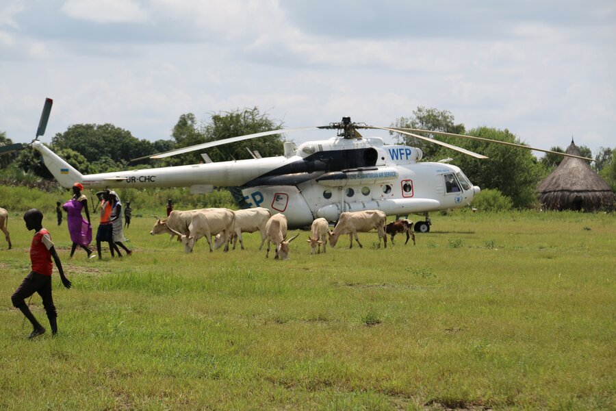 Orange parachutes rain down from a blue sky | World Food Programme